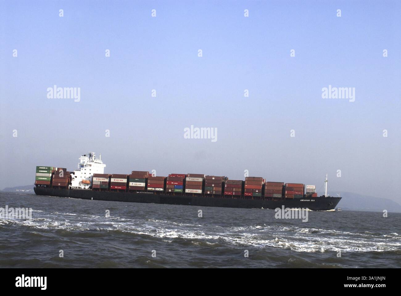 Huge container ship fully loaded in port terminal Stock Photo - Alamy