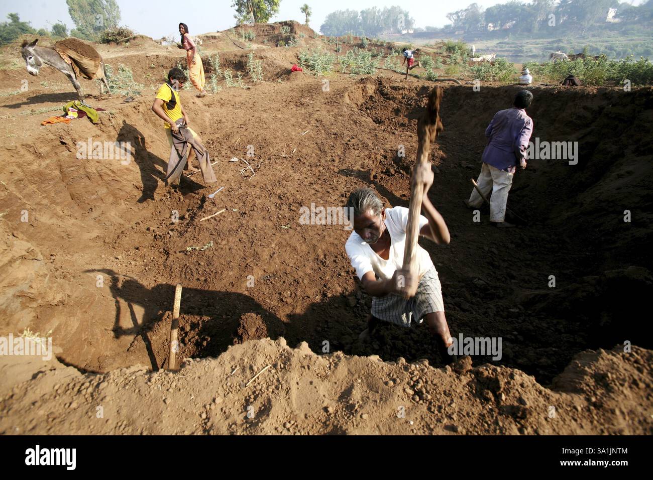 A family of brick makers collecting mud for making bricks in village of ...