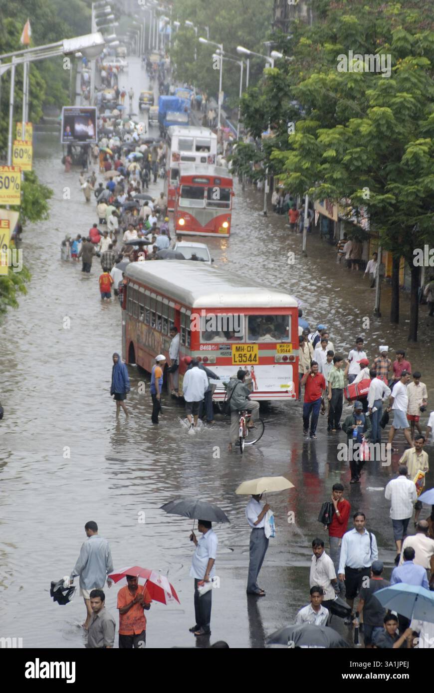 Monsoon, people walking through flooded road heavy rain in Parel ...