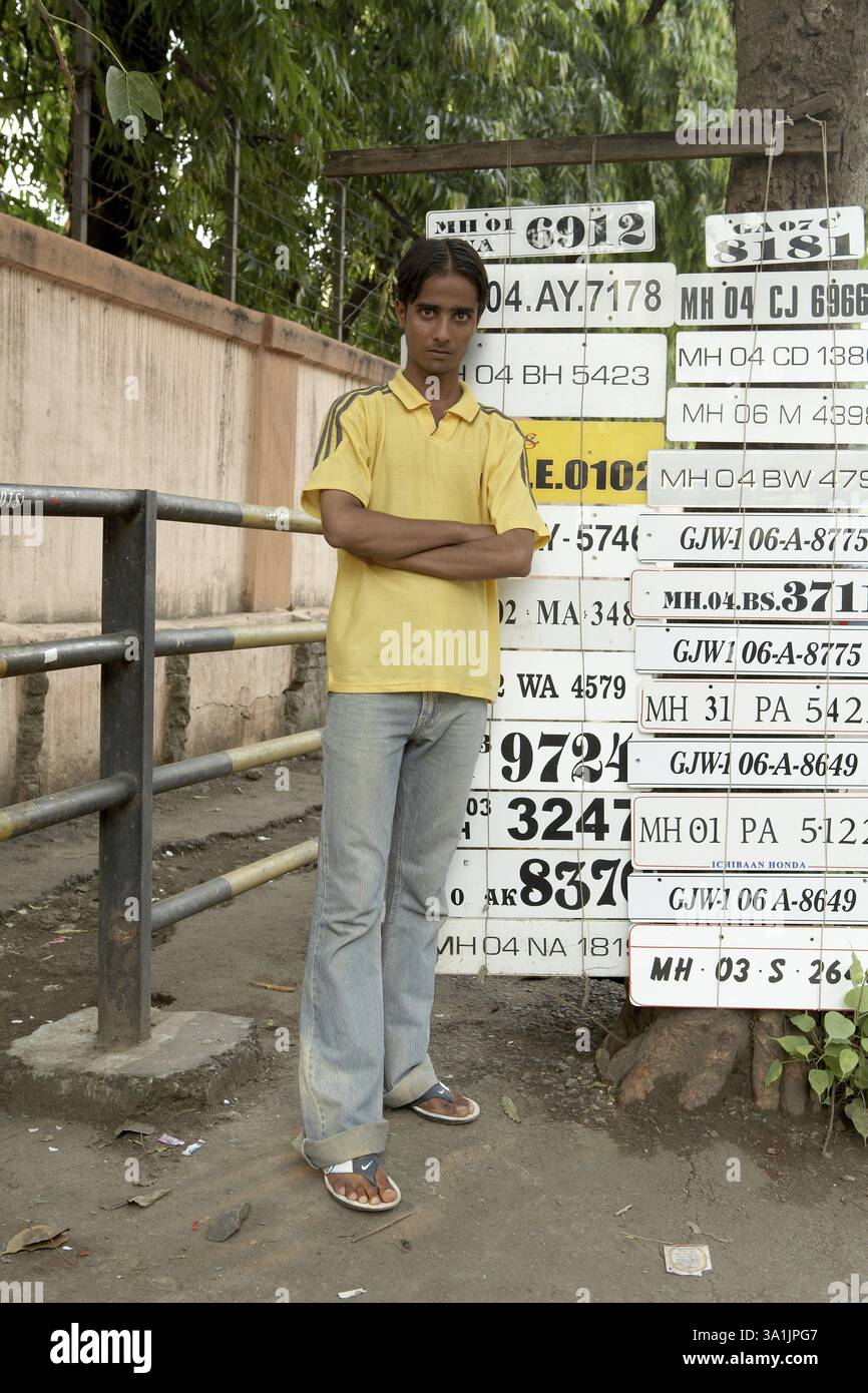 A vehicle number plate engraver artist with the display of his various ...