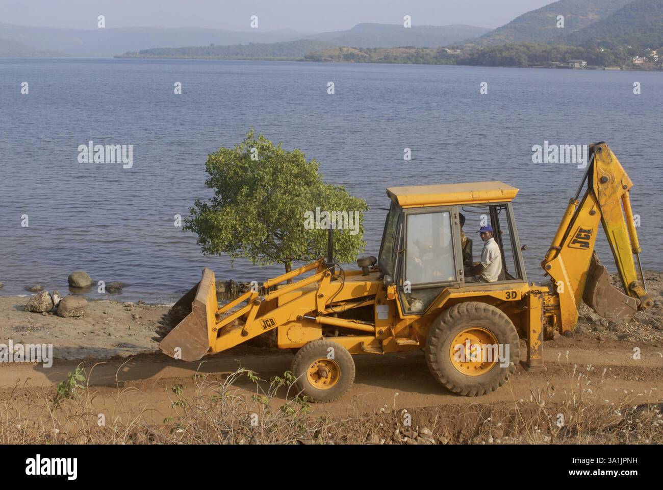 JCB3D, excavator and digger at work, mangroves and marshy land of ...