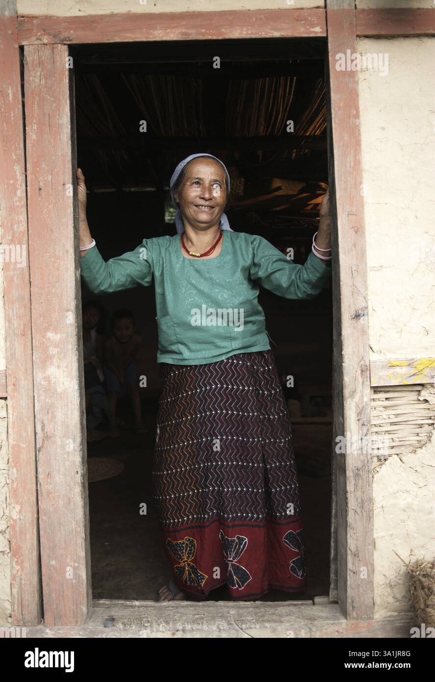 Rural old woman standing in door of house, Pastanga, Sikkim, India ...