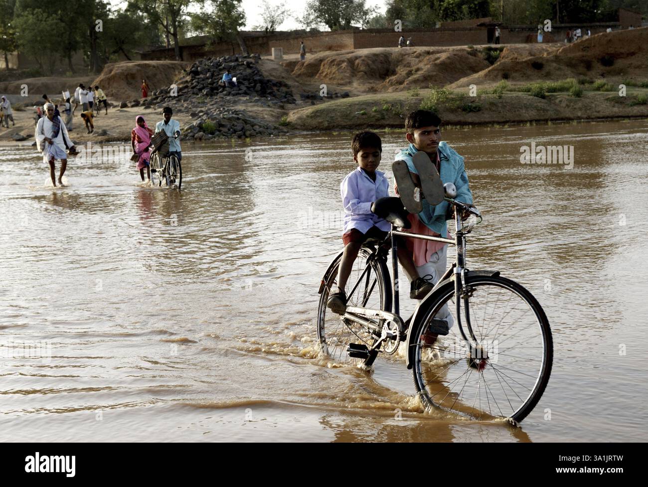 People walking in shallow river water, Garwa and Latehar, Jharkhand ...