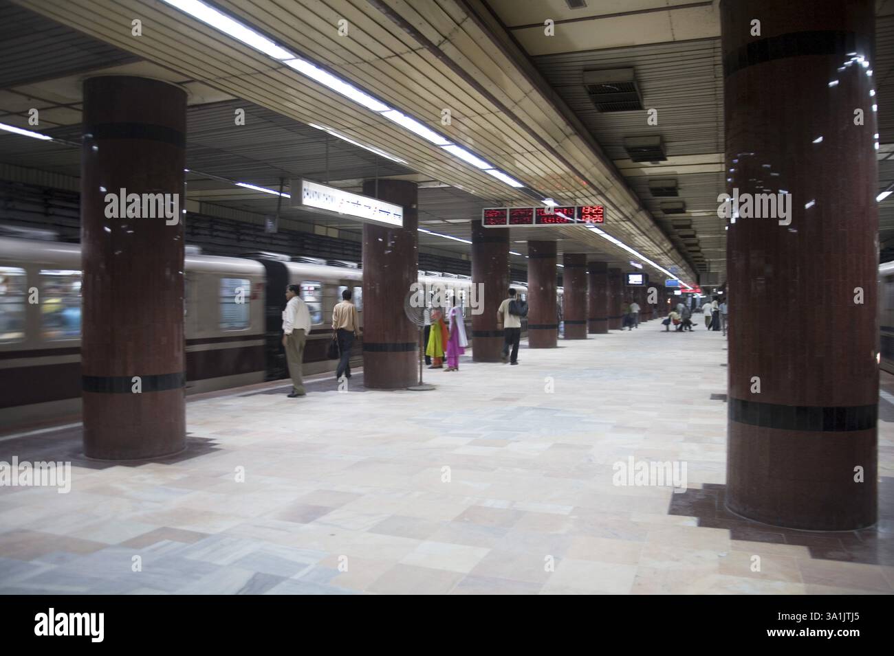 Underground Metro railway train passing and passengers waiting on ...