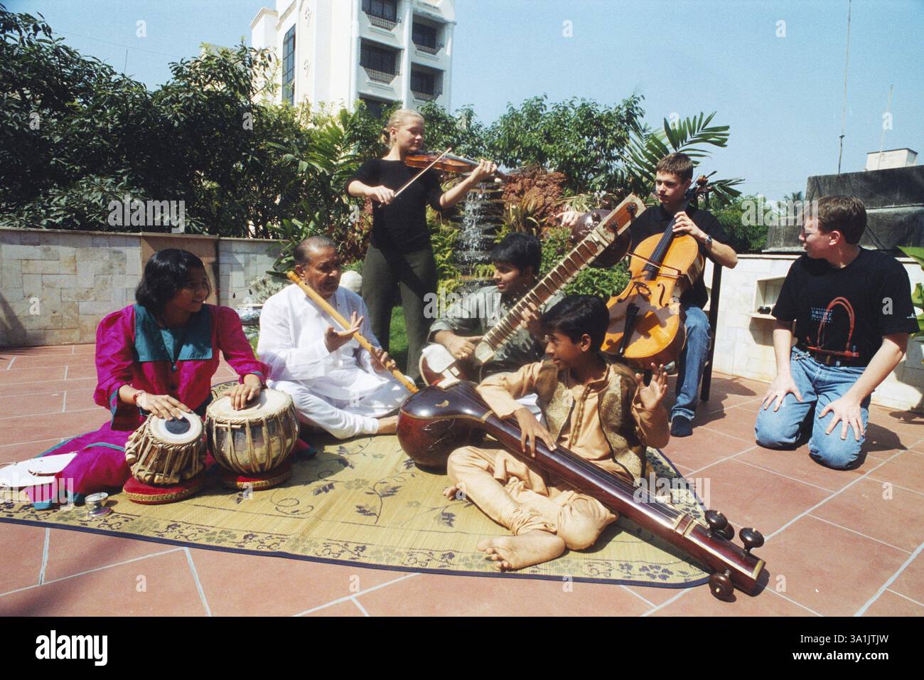Children playing musical instrument with Indian classical music maestro ...