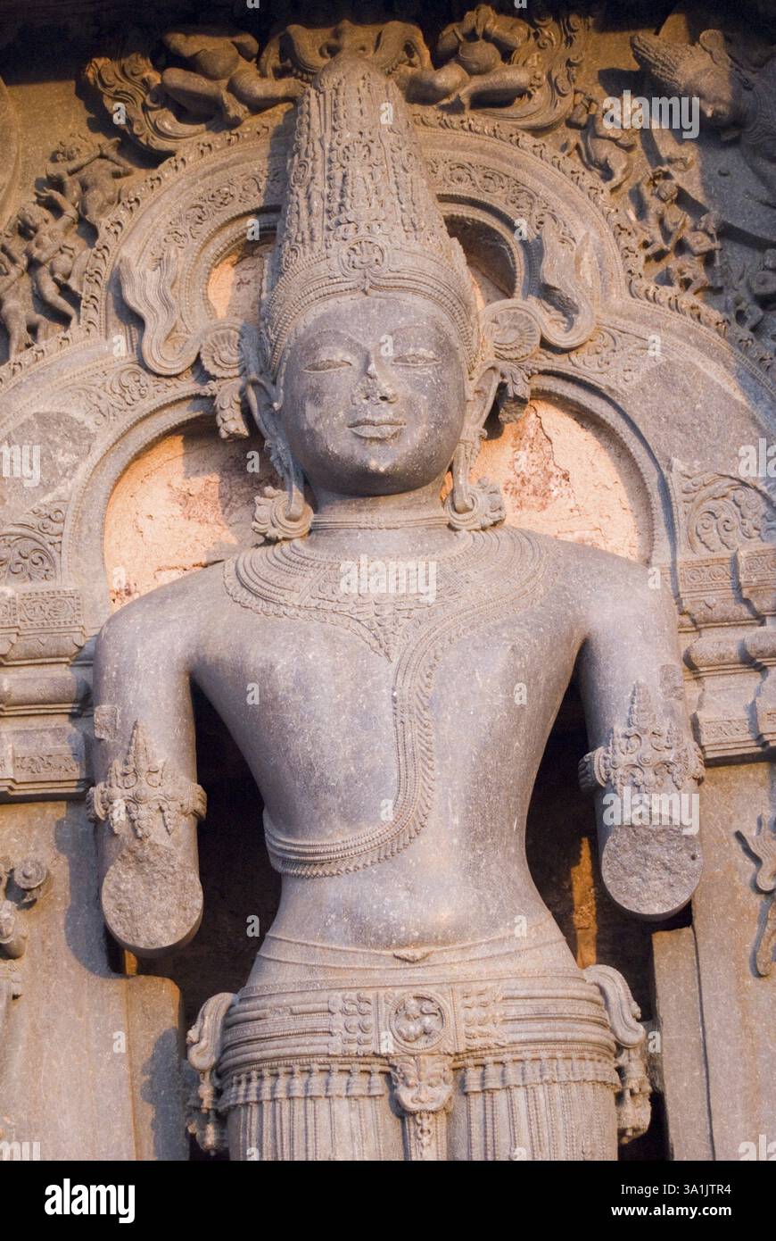 Statue of Vedic Sun god Surya or Arka in mellow mood carved on wall of ...