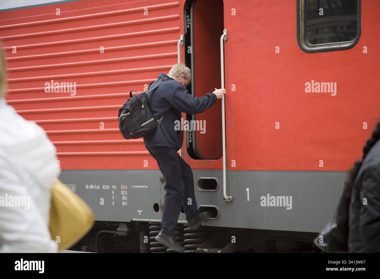 Train driver getting down from engine red color train, German railway ...