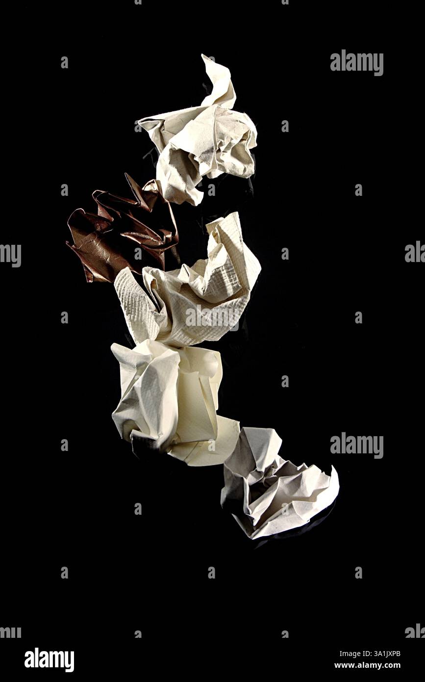 Crumpled paper, paper sculpture fine art on black background Stock ...