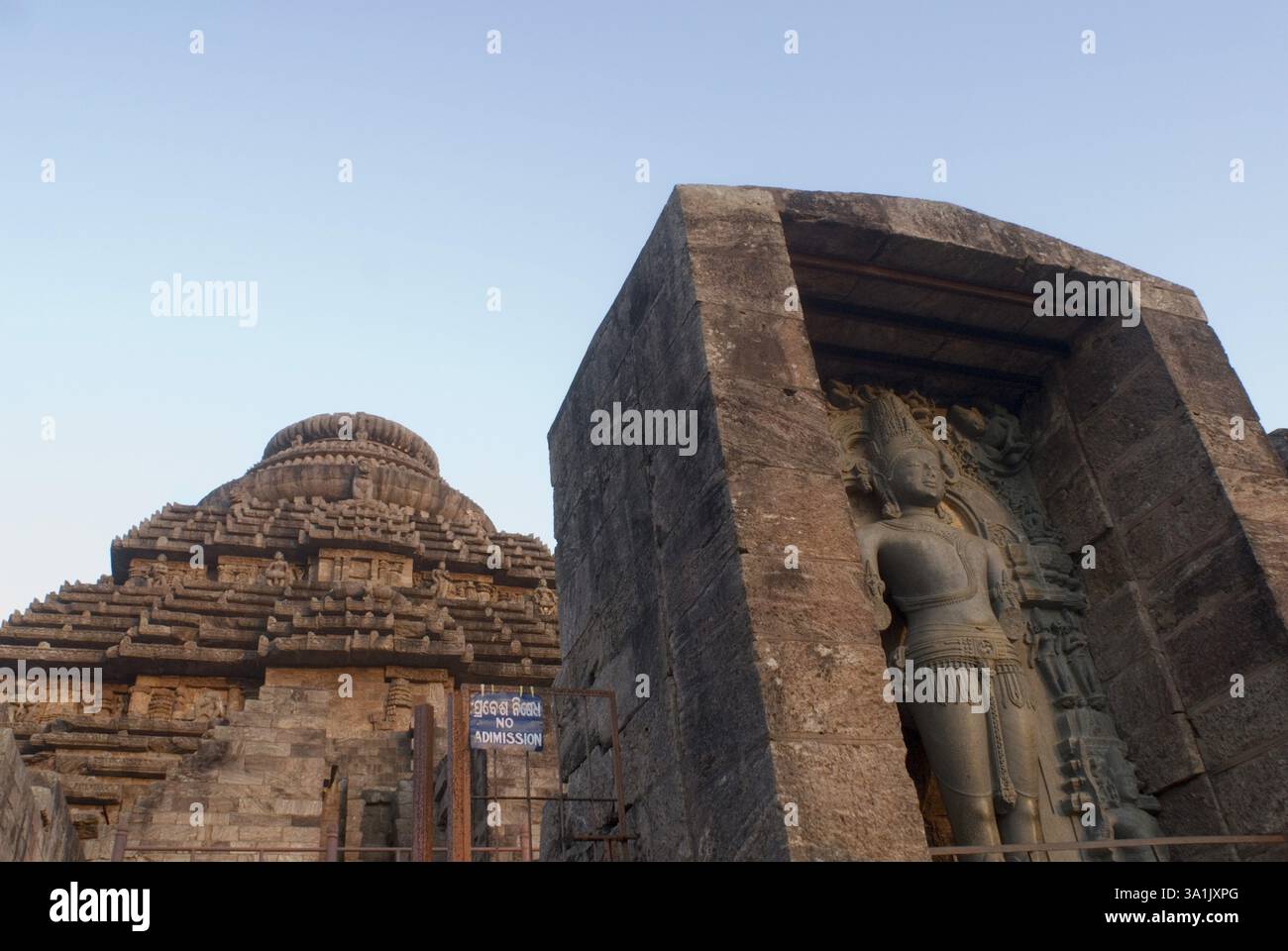 Statue of Vedic Sun god Surya or Arka in mellow mood carved on wall of ...