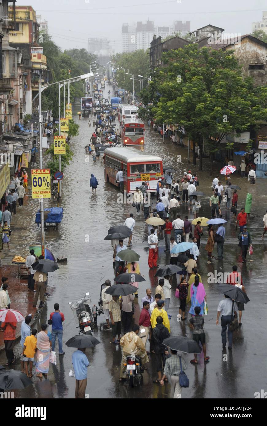 Monsoon, people walking through flooded road heavy rain in Parel ...