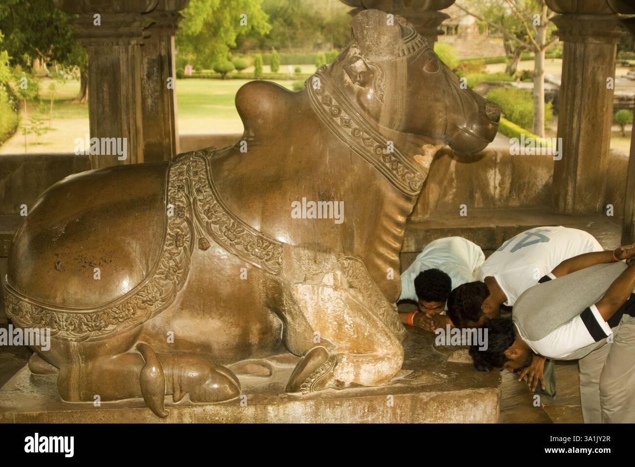 Nandi shrine men worshiping in front of Vishwanath temple at Khajuraho ...