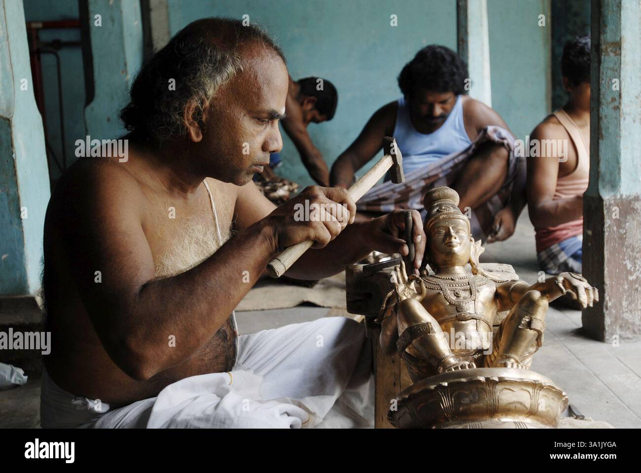 Sculptors carved bronze icon with chisel Stock Photo - Alamy