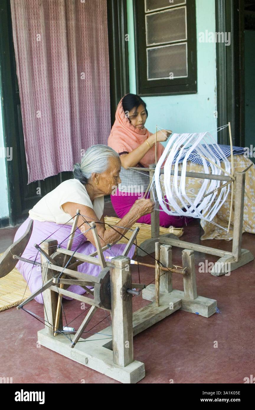 Tribal woman weaving on spinning wheel or charka, Meiteis, Imphal ...