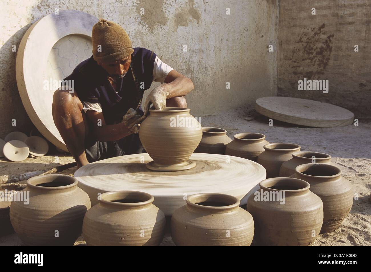 Pottery, potter giving shape to clay pot on wheel, Bikaner, Rajasthan ...