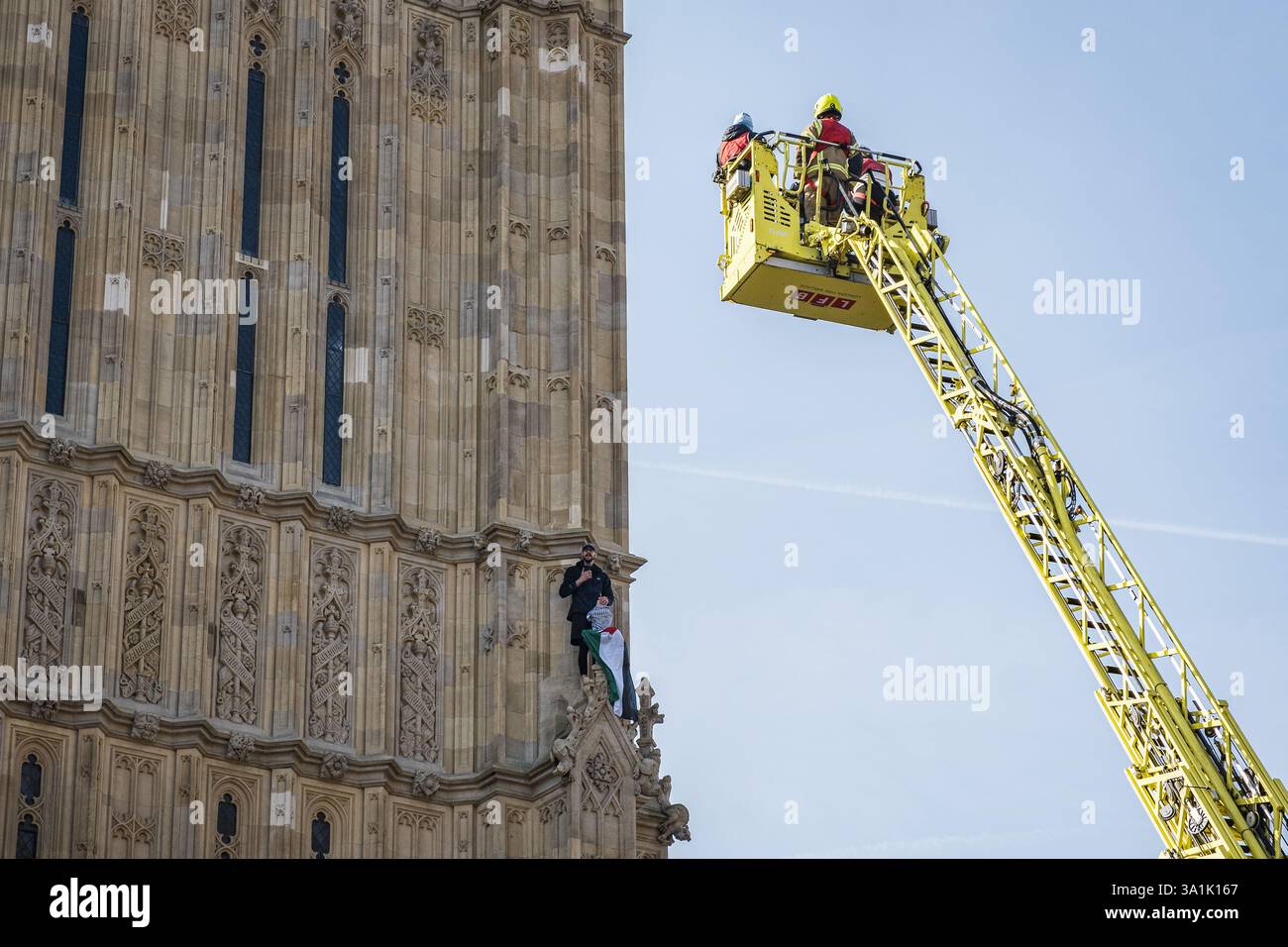 London, UK. 08th Mar, 2025. A barefoot man with a Palestine flag is seen on Elizabeth Tower, a ...