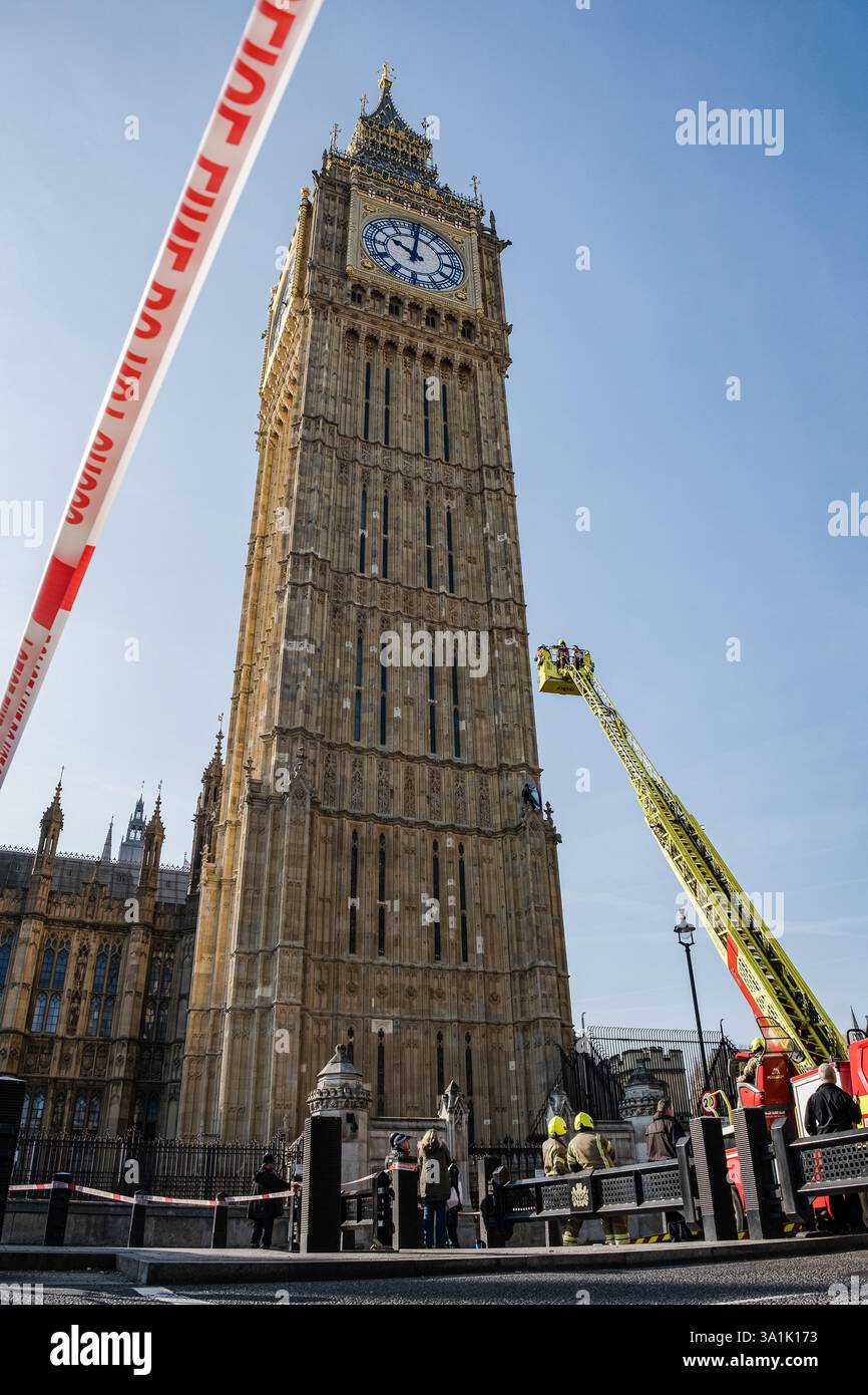 A barefoot man with a Palestine flag is seen on Elizabeth Tower, a fire rescue platform from ...