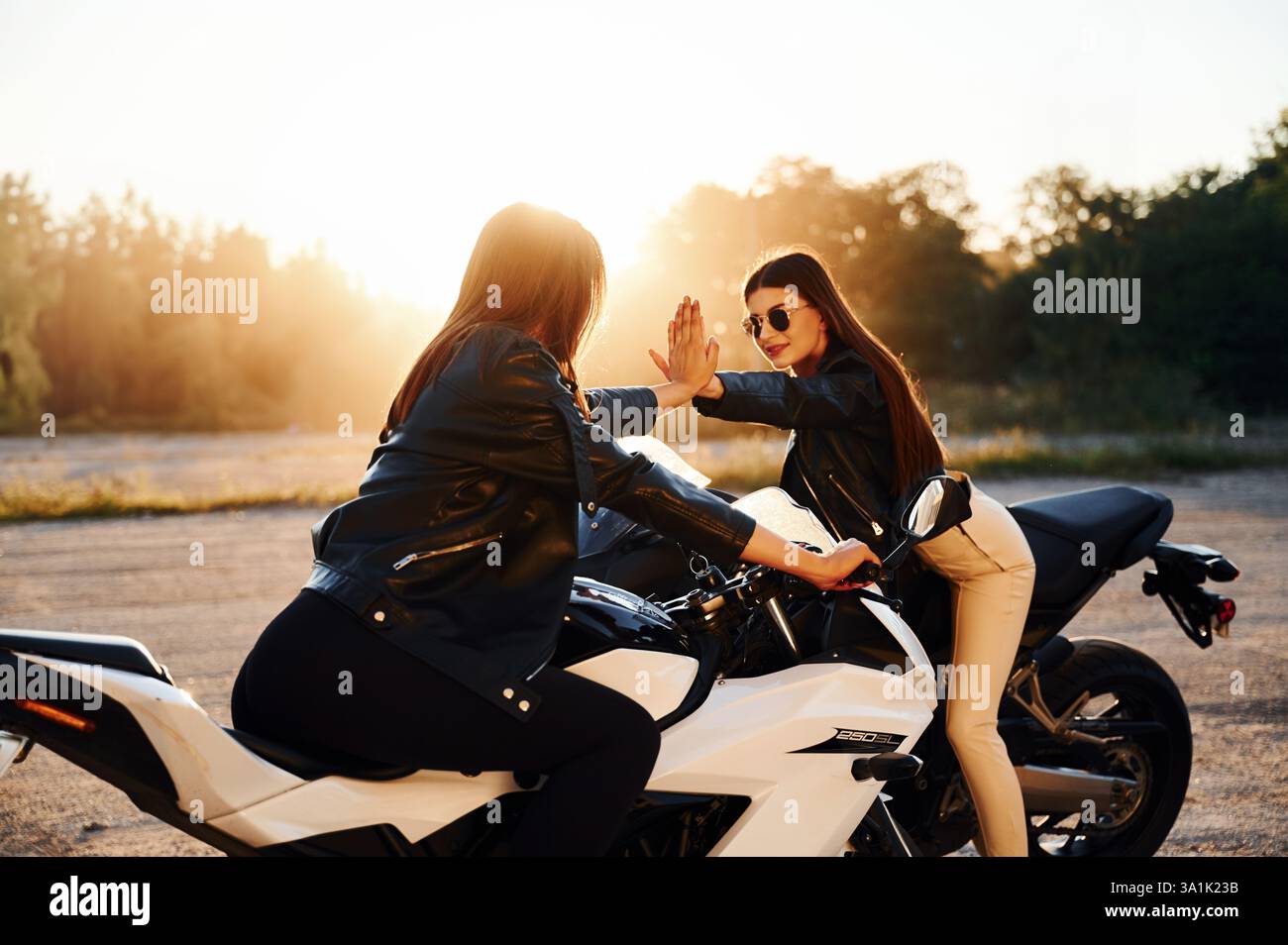 Two women on motorcycles are together outdoors Stock Photo - Alamy