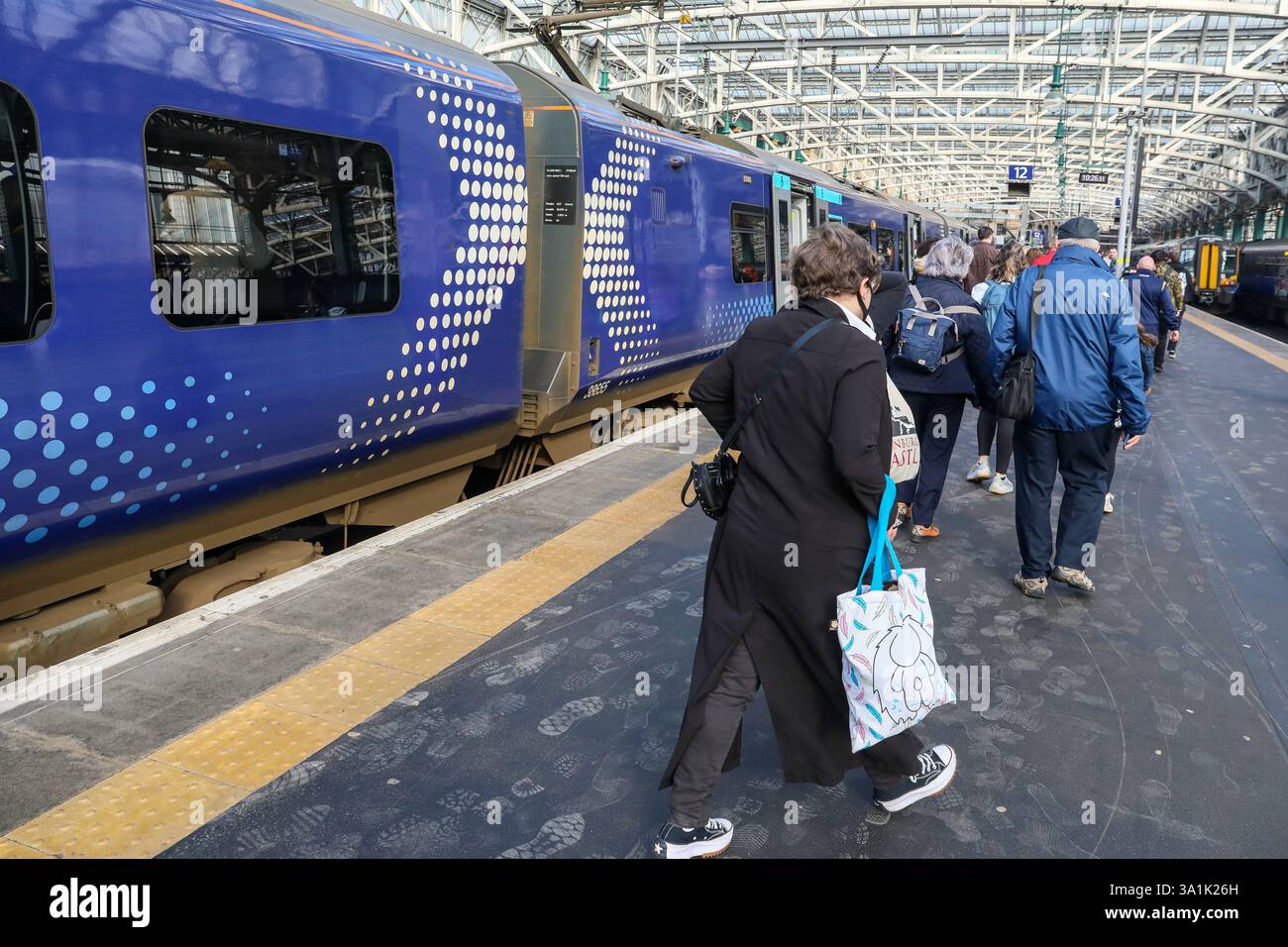 Passengers leaving a Scotrail train and walking off the platform at ...