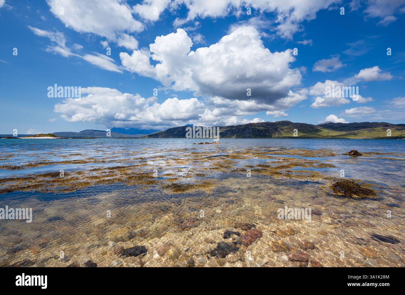Shallow shoreline waters of Loch Eishort with Black Cuillin mountains ...