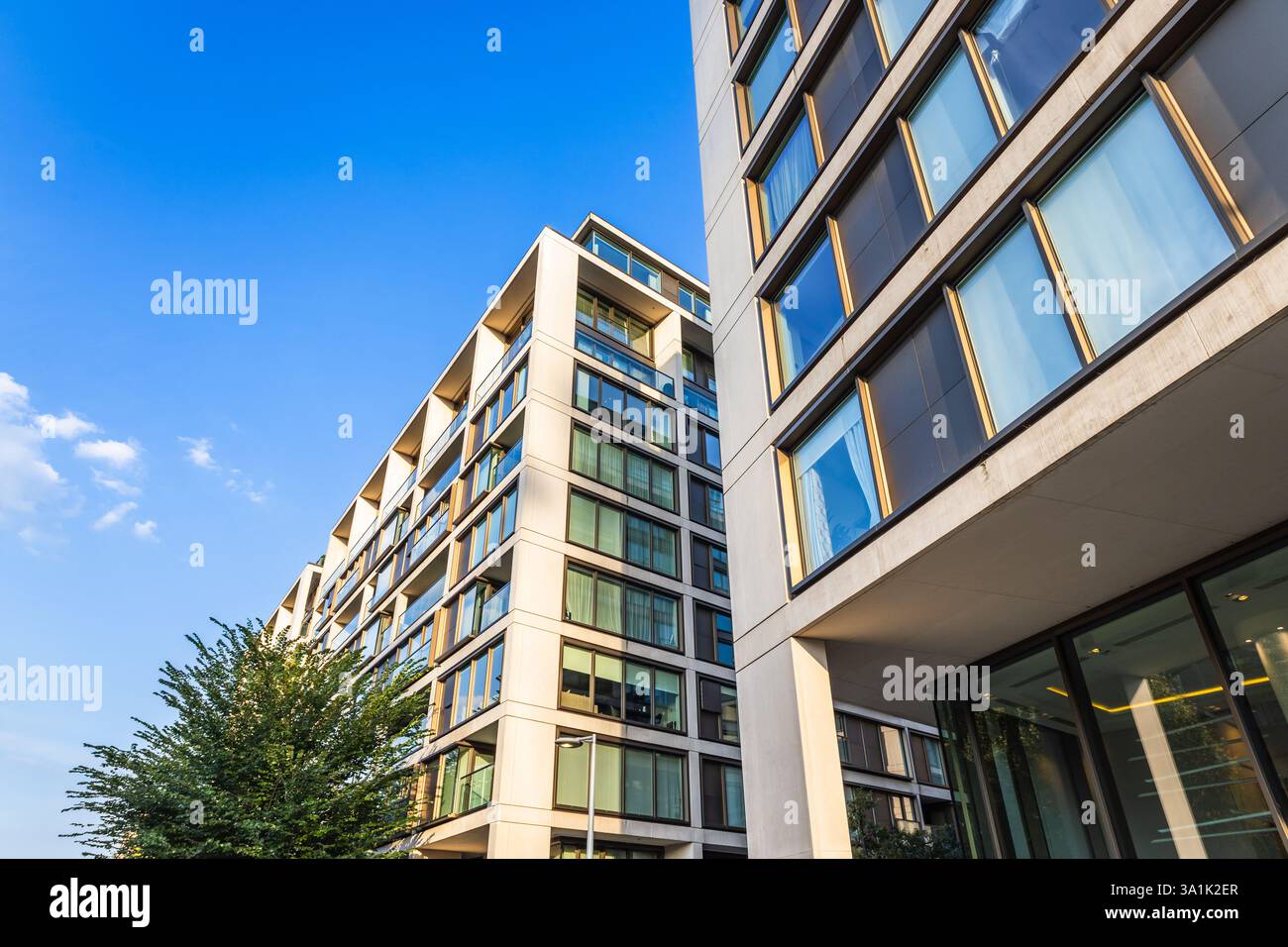 Sleek Apartment Complex Featuring Clean Lines and Greenery Under a ...