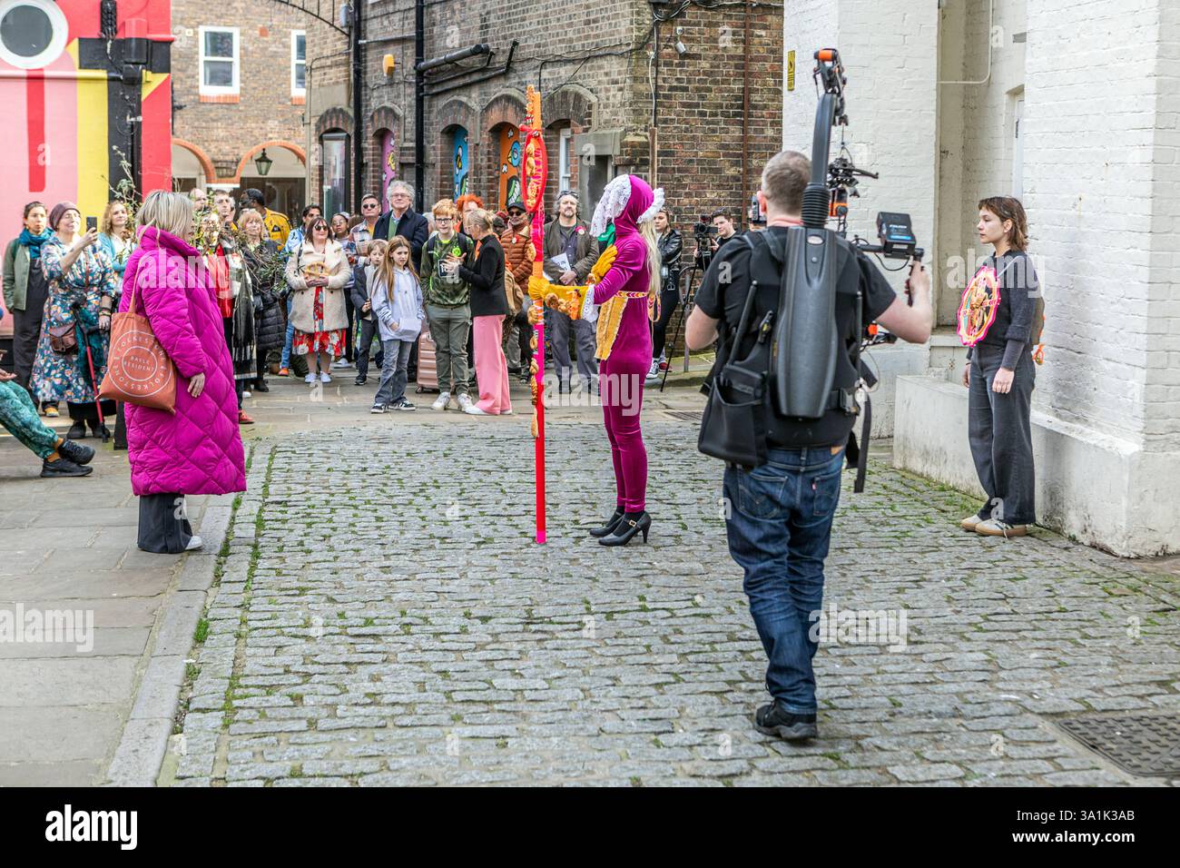 A crowd of people watching part of the parade for International women's ...