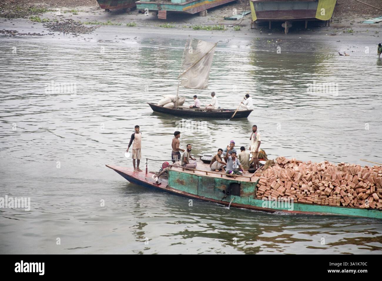 People and bricks traveling in boat in Burigunga Buri Gunga River, Sadarghat Boat terminal ...