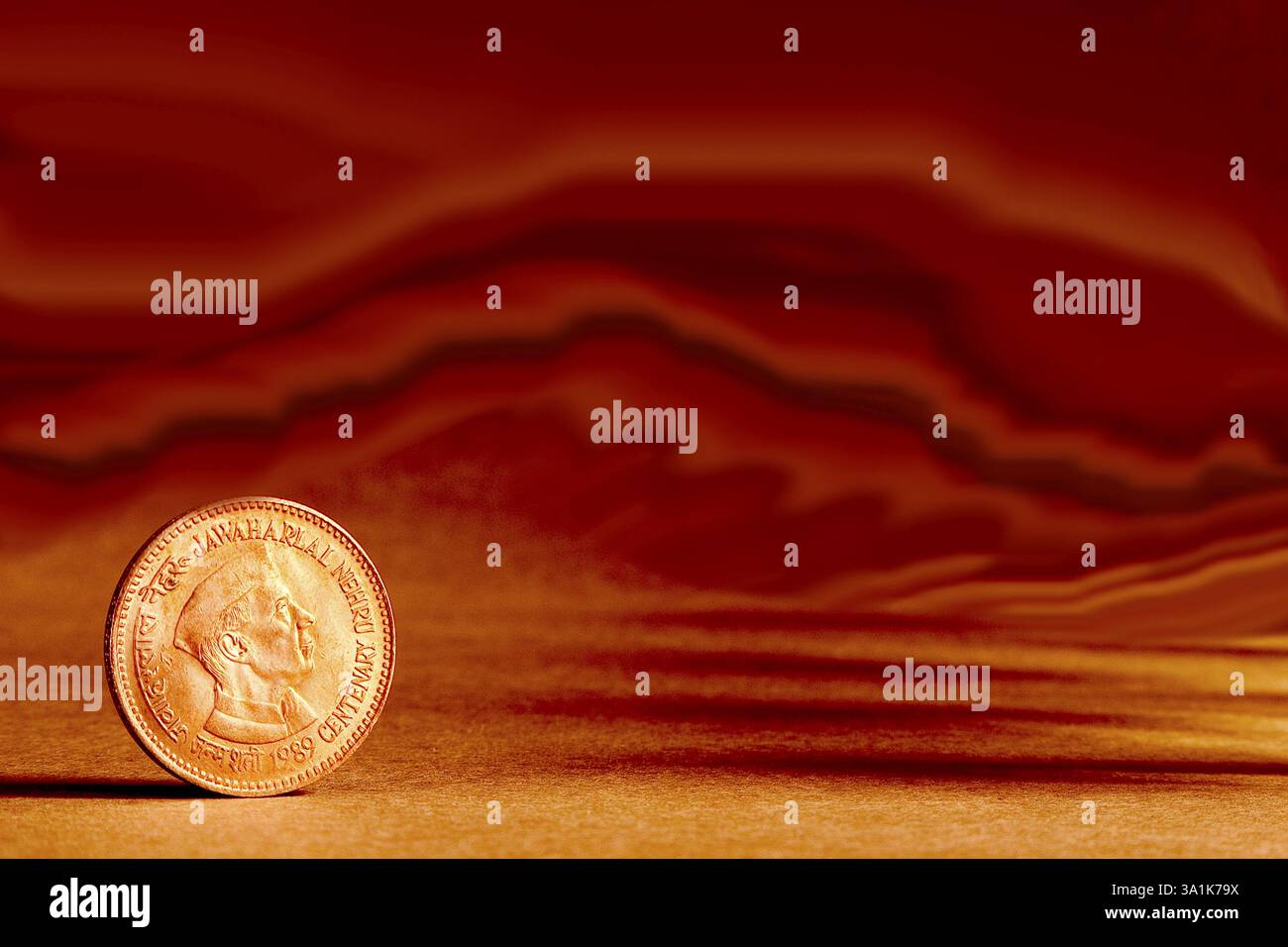One single Indian currency five rupees coin and artistic background ...