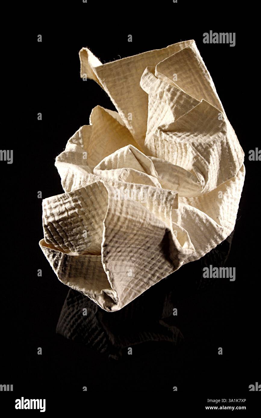 Crumpled paper, paper sculpture fine art on black background Stock ...