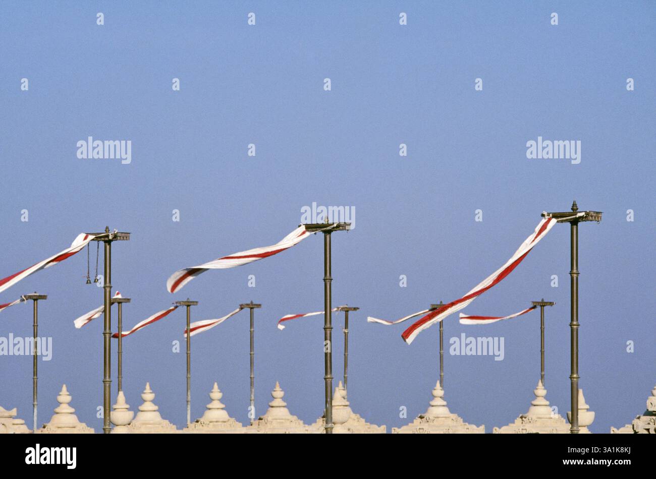 Red and white flags fluttering above Jain temples in Palitana, Gujarat ...