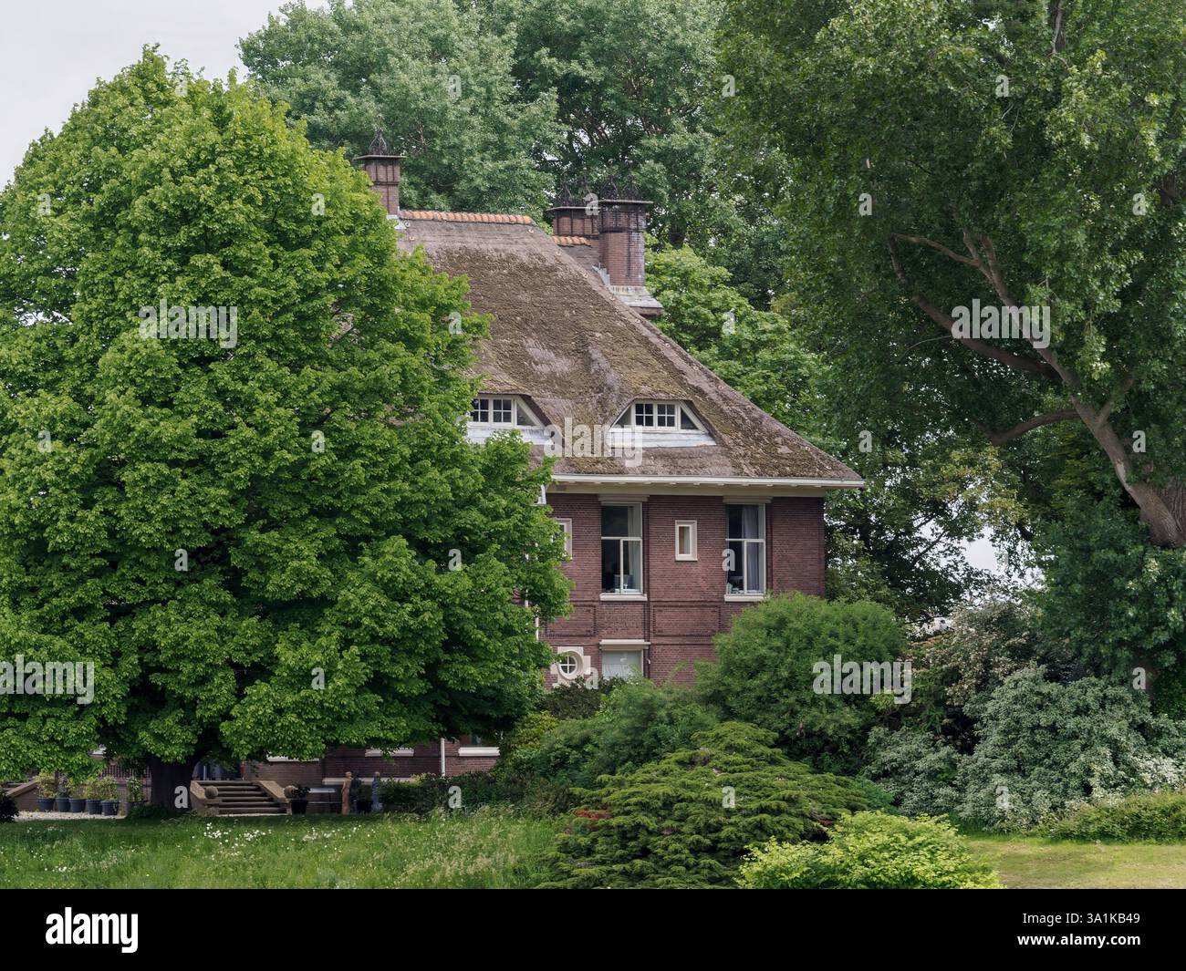 Charming brick house surrounded hi-res stock photography and images - Alamy