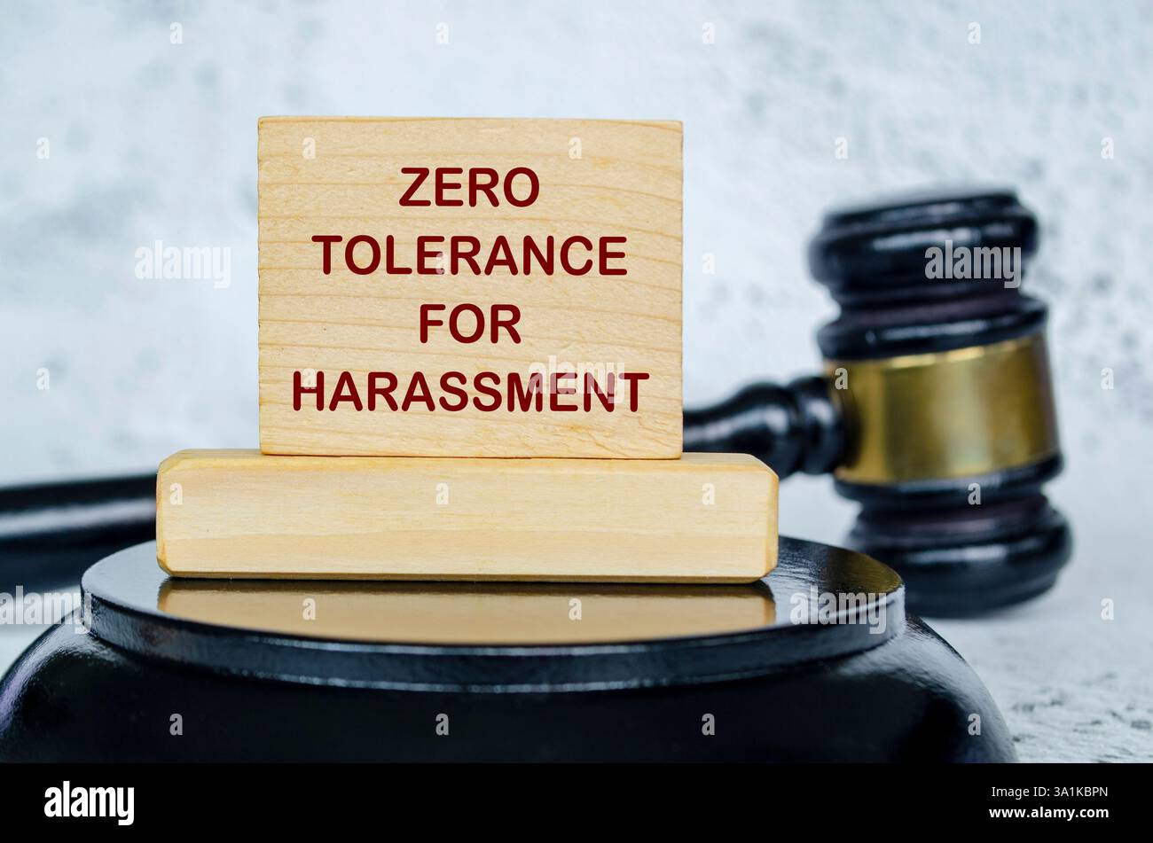 Zero Tolerance For Harassment text written on wooden board with lawyer gavel background ...