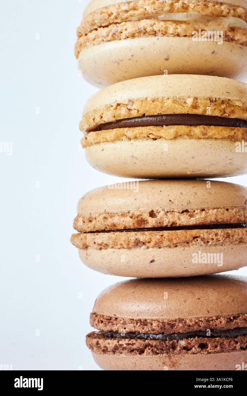 Stack of four brown French Macarons, cakes with different flavors ...