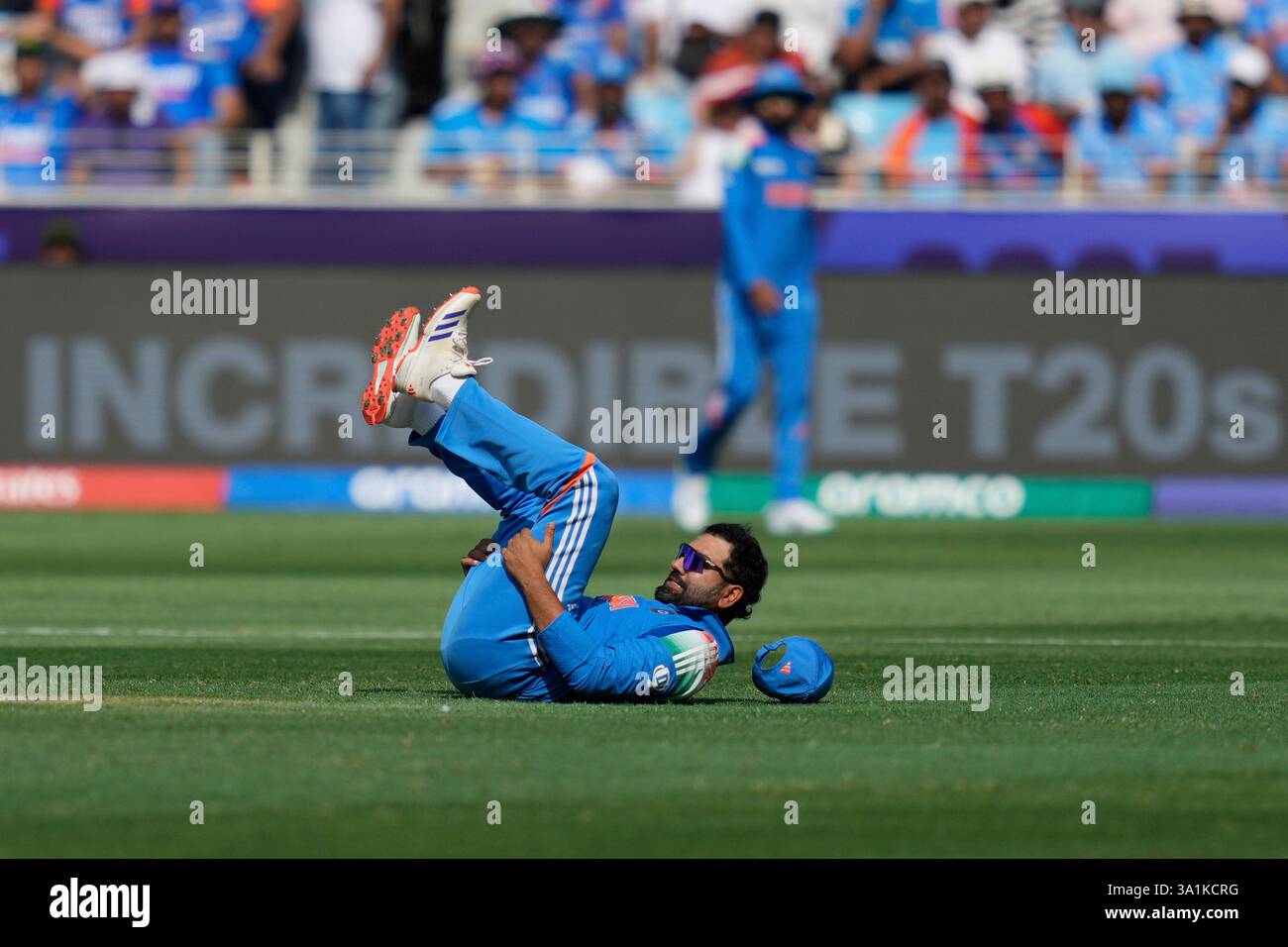 India's captain Rohit Sharma falls after failing to take the catch of ...