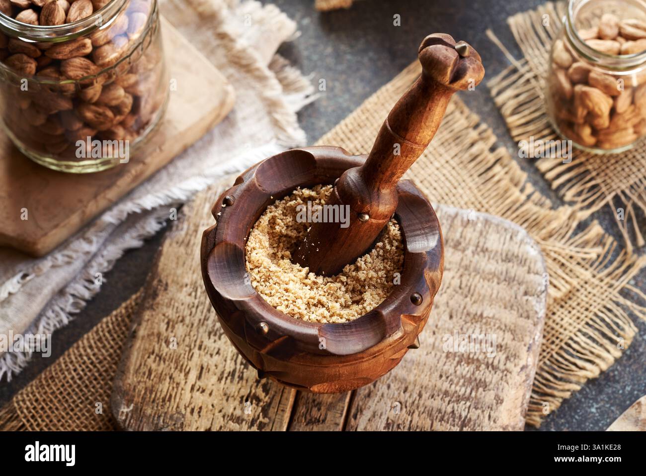 Preparation of homemade hazelnut butter in a wooden mortar on a table ...