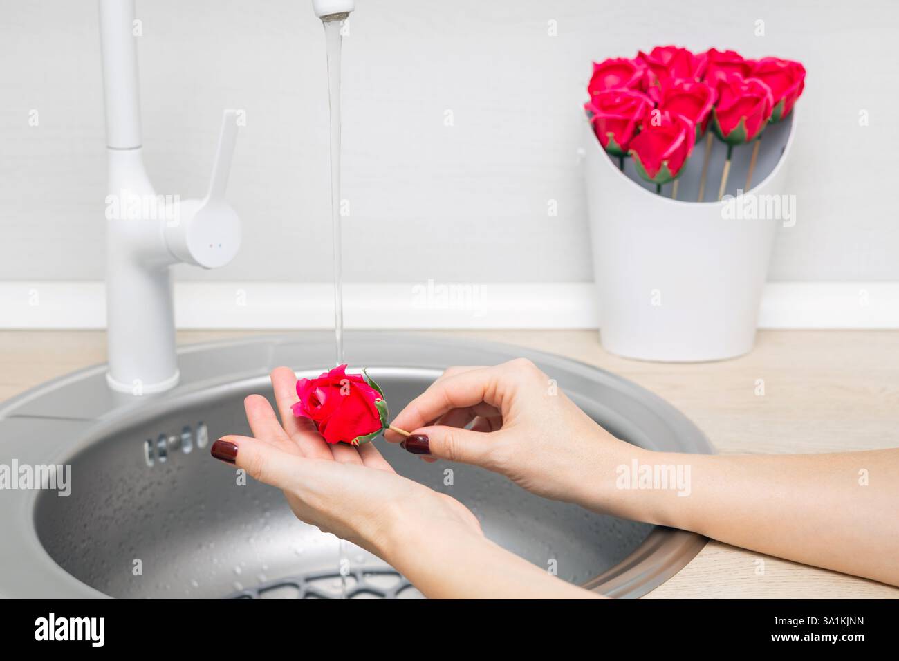 woman washing her hands with flower shaped soap. red rose shaped soap ...