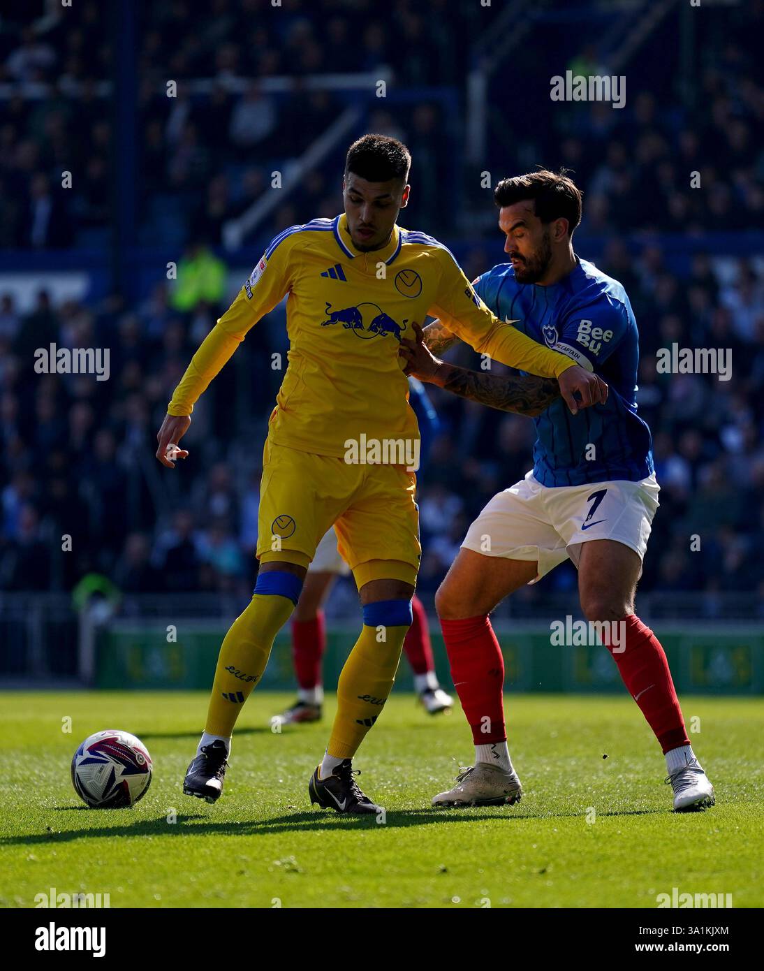 Leeds United's Joel Piroe (left) and Portsmouth's Marlon Pack (right ...