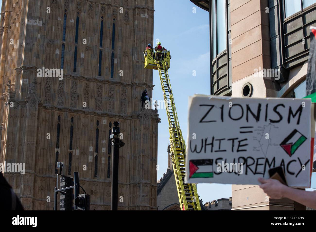 Firefighters try to convince the activist to stop his action at the ...