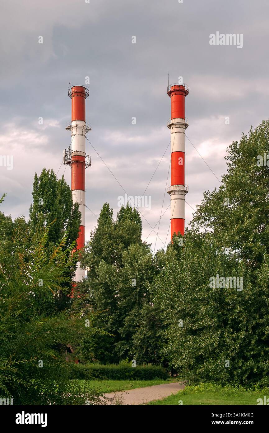 Two chimneys of the boiler house rise in the city neighbourhood. In ...