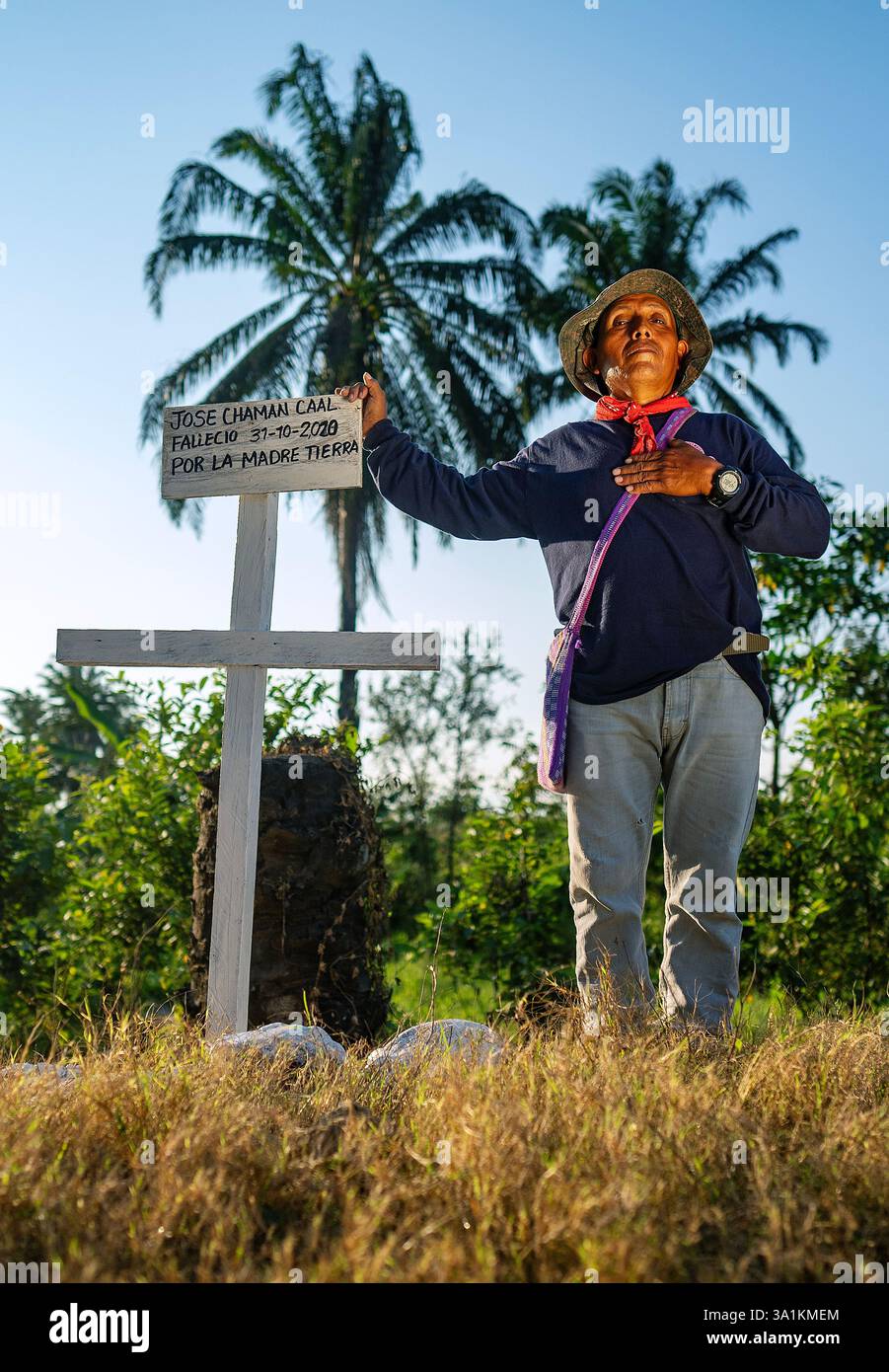 Community leader Domingo Choc Tiul stands beside a cross erected for ...