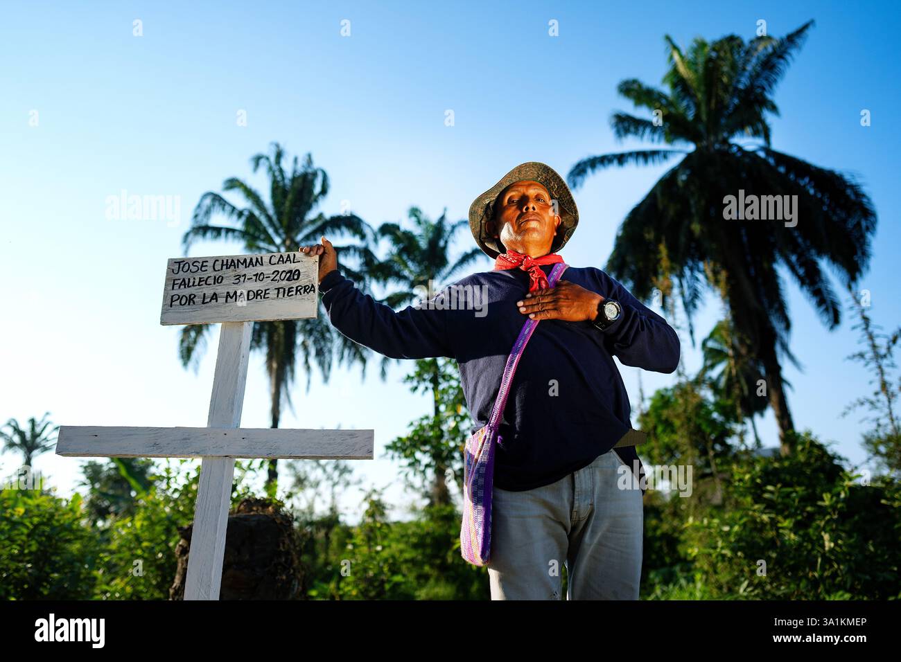 Community leader Domingo Choc Tiul stands beside a cross erected for ...