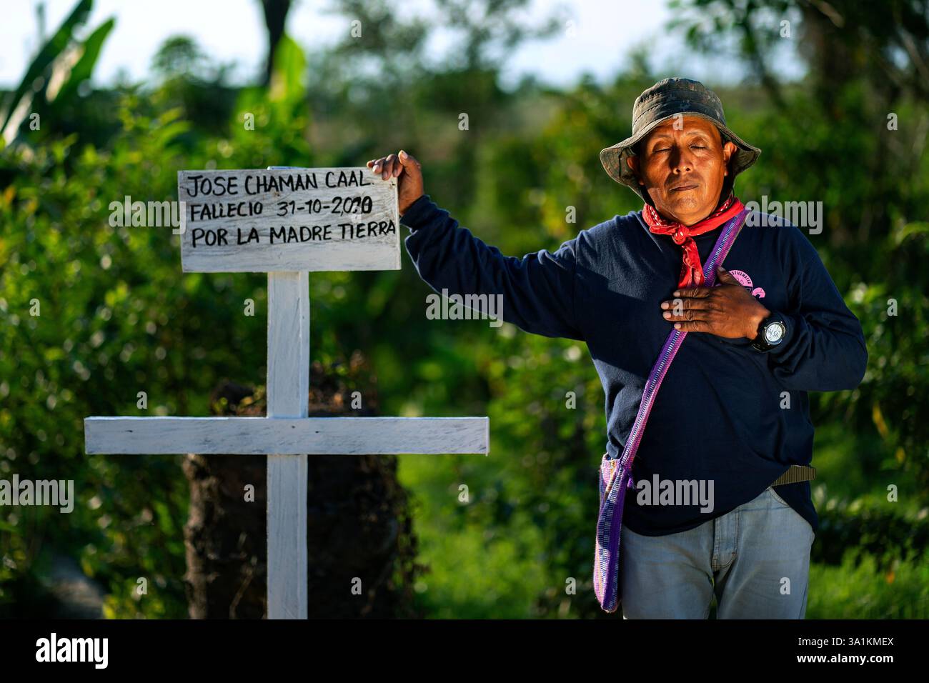 Community leader Domingo Choc Tiul stands beside a cross erected for ...
