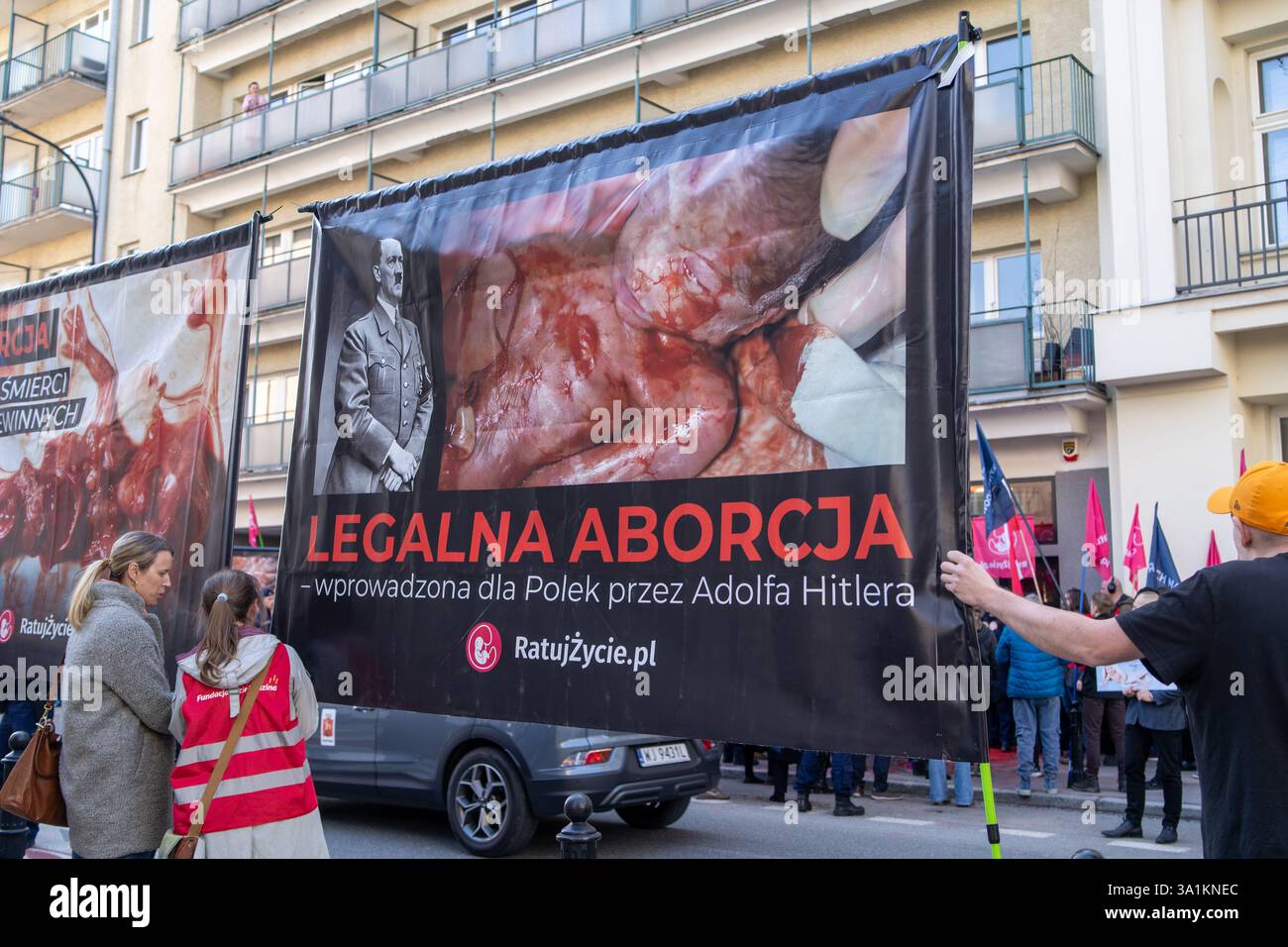 Protesters against abortion are seen holding a banner saying: "Abortion ...