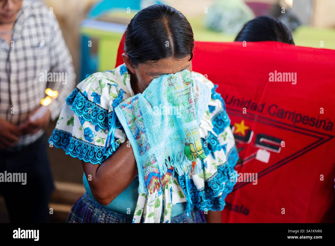 A woman covers her face during a ceremony in the Q'eqchi village of ...