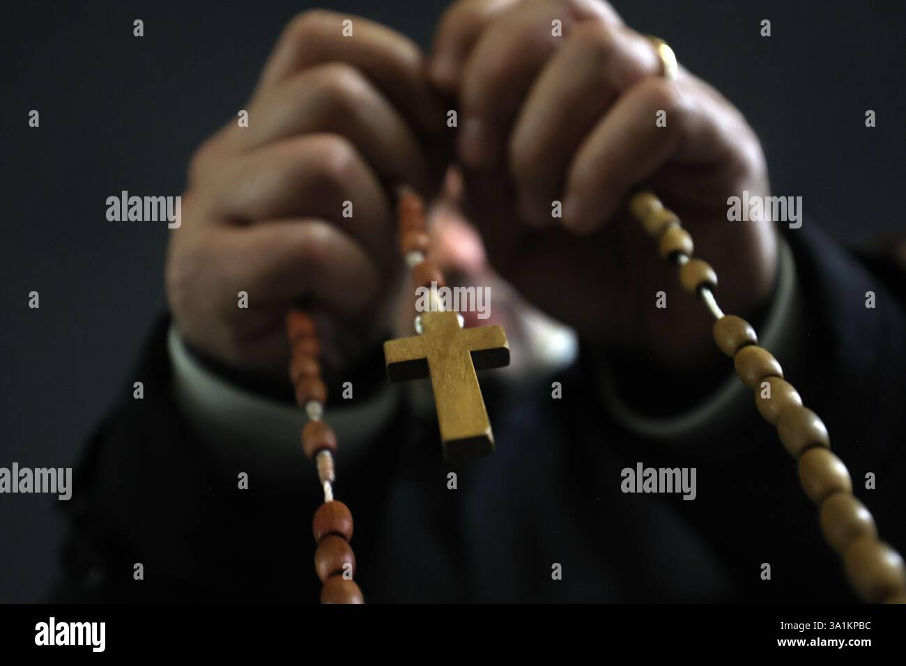 hands hold the holy rosary during prayer by Cardinal Michael Czerny ...