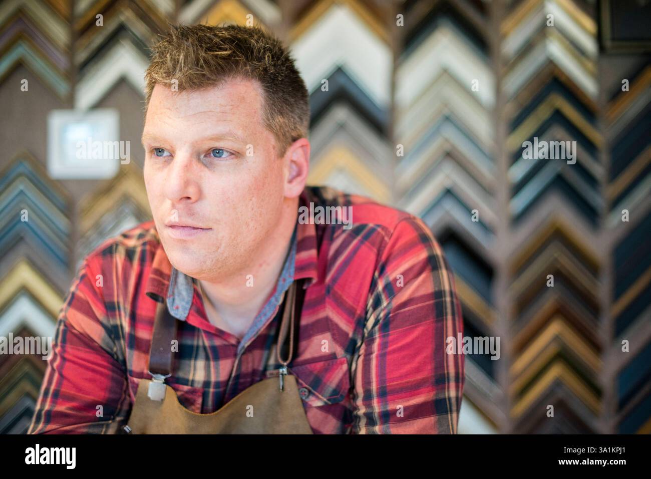 Framemaker inside his workshop Goirle, Netherlands. Mid adult male ...