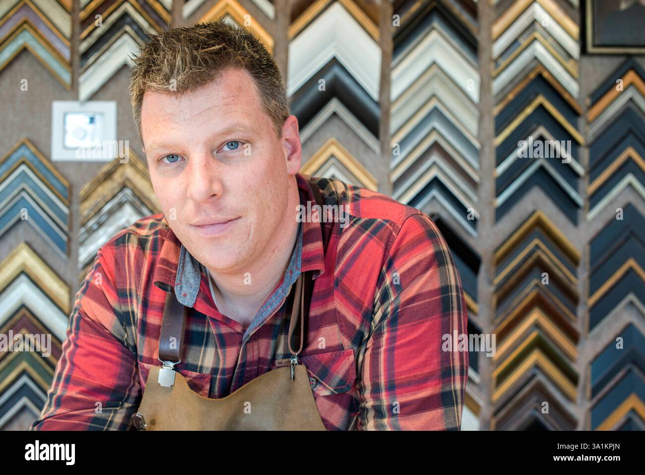 Framemaker inside his workshop Goirle, Netherlands. Mid adult male ...
