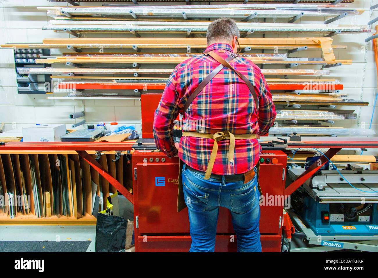 Craftsman working inside Workshop Goirle, Netherlands. Mid adult male craftsman and picture ...