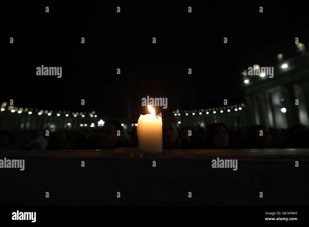 A candle lit for the pontiff during the rosary prayer celebrated by ...
