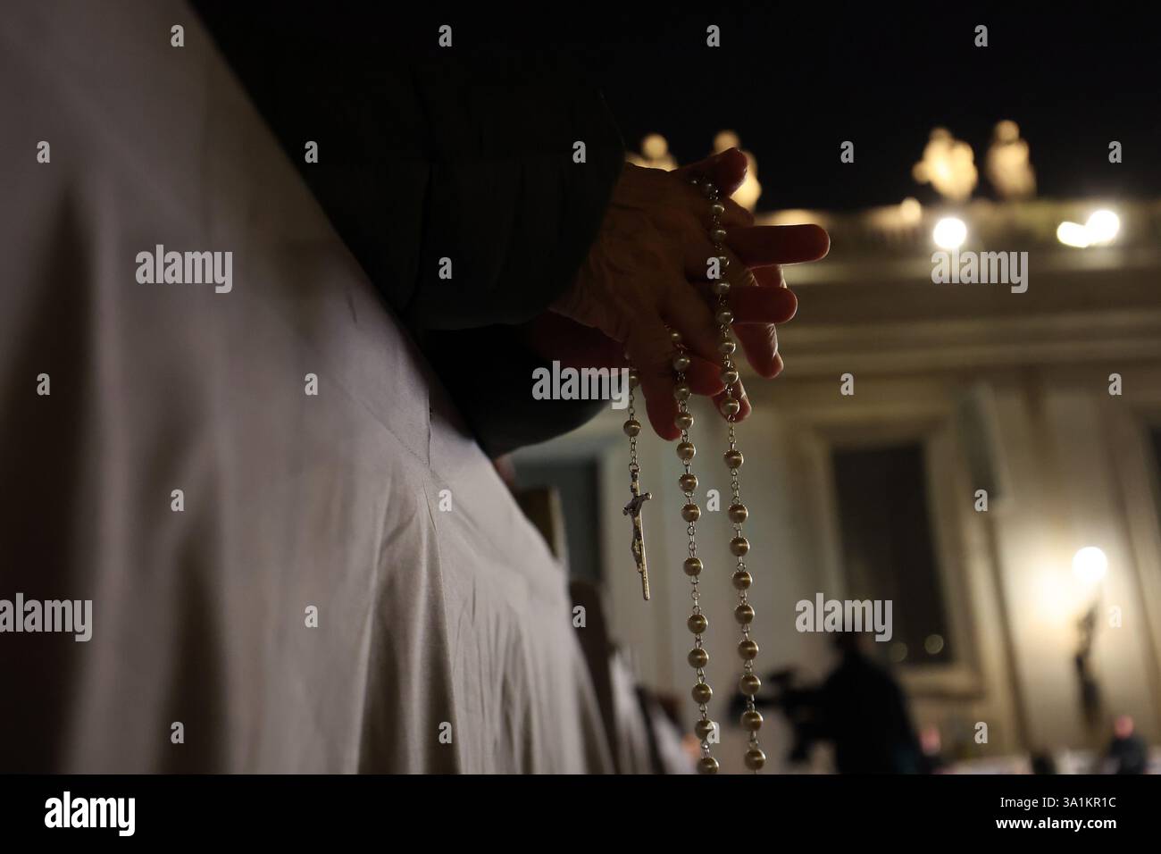 Hands hold the holy rosary during prayer by Cardinal Michael Czerny ...