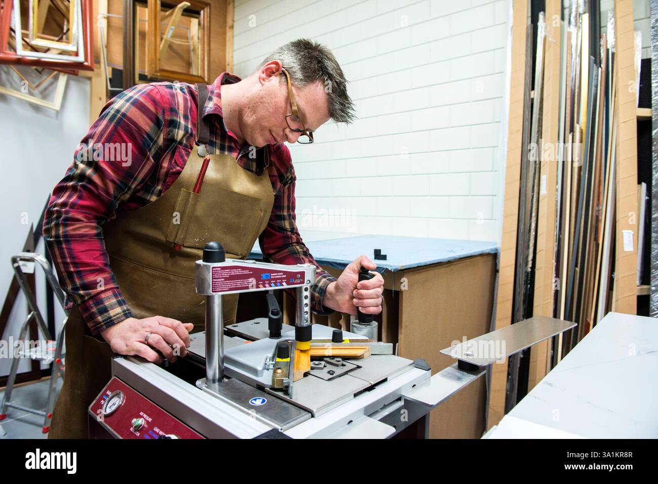 Framemaker inside his workshop Goirle, Netherlands. Mid adult male craftsman and picture ...